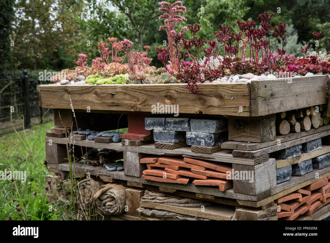 Close up of large bug house with several layers of different materials ...