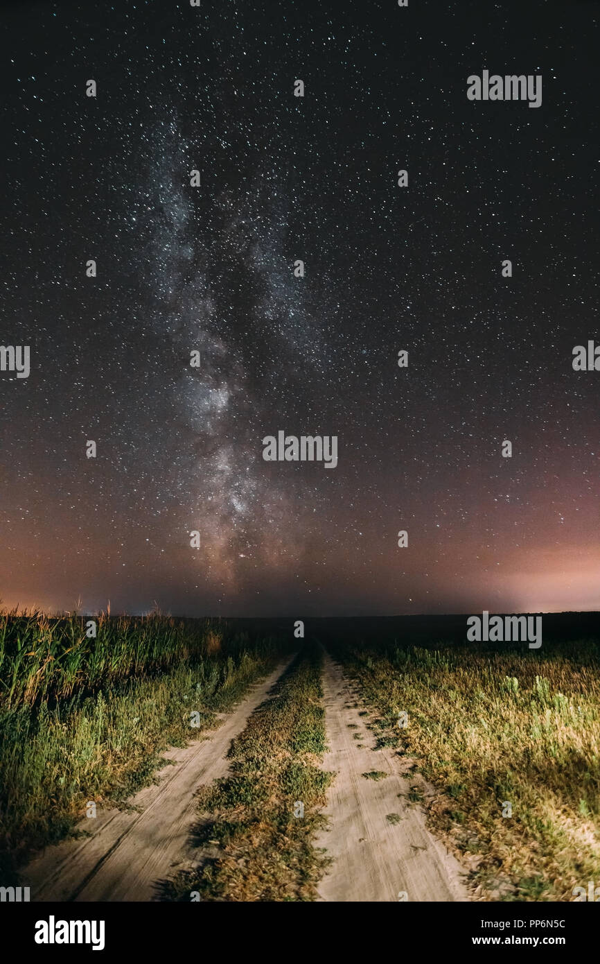 Night Starry Sky With Milky Way Glowing Stars Above Country Road In ...