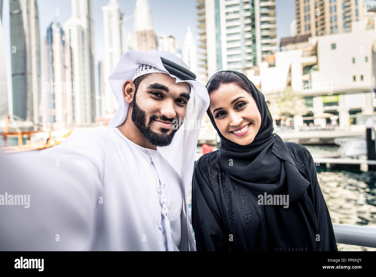Arabic couple with traditional clothes dating outdoors Stock Photo - Alamy