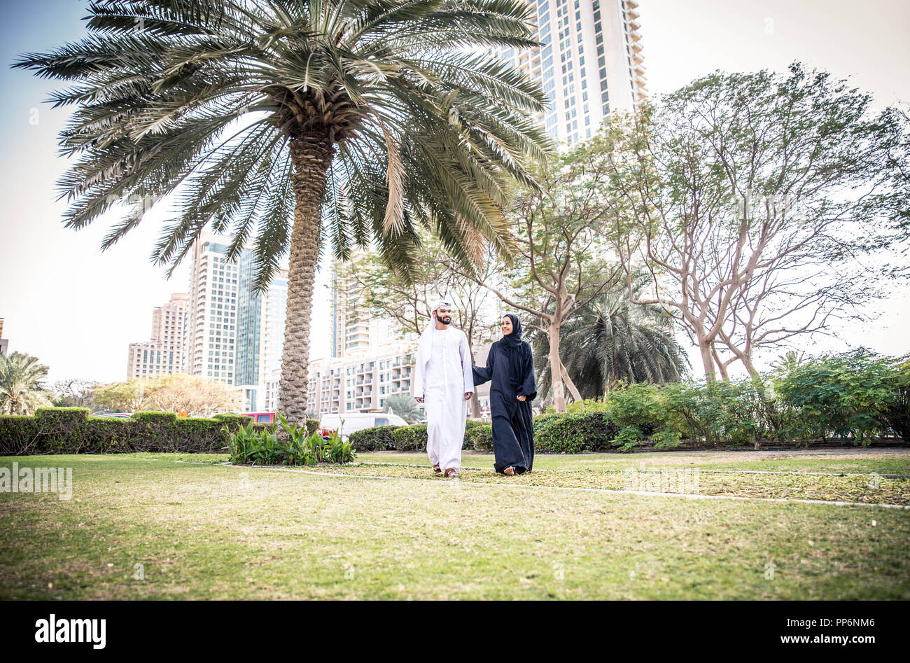 Arabic couple with traditional clothes dating outdoors Stock Photo - Alamy