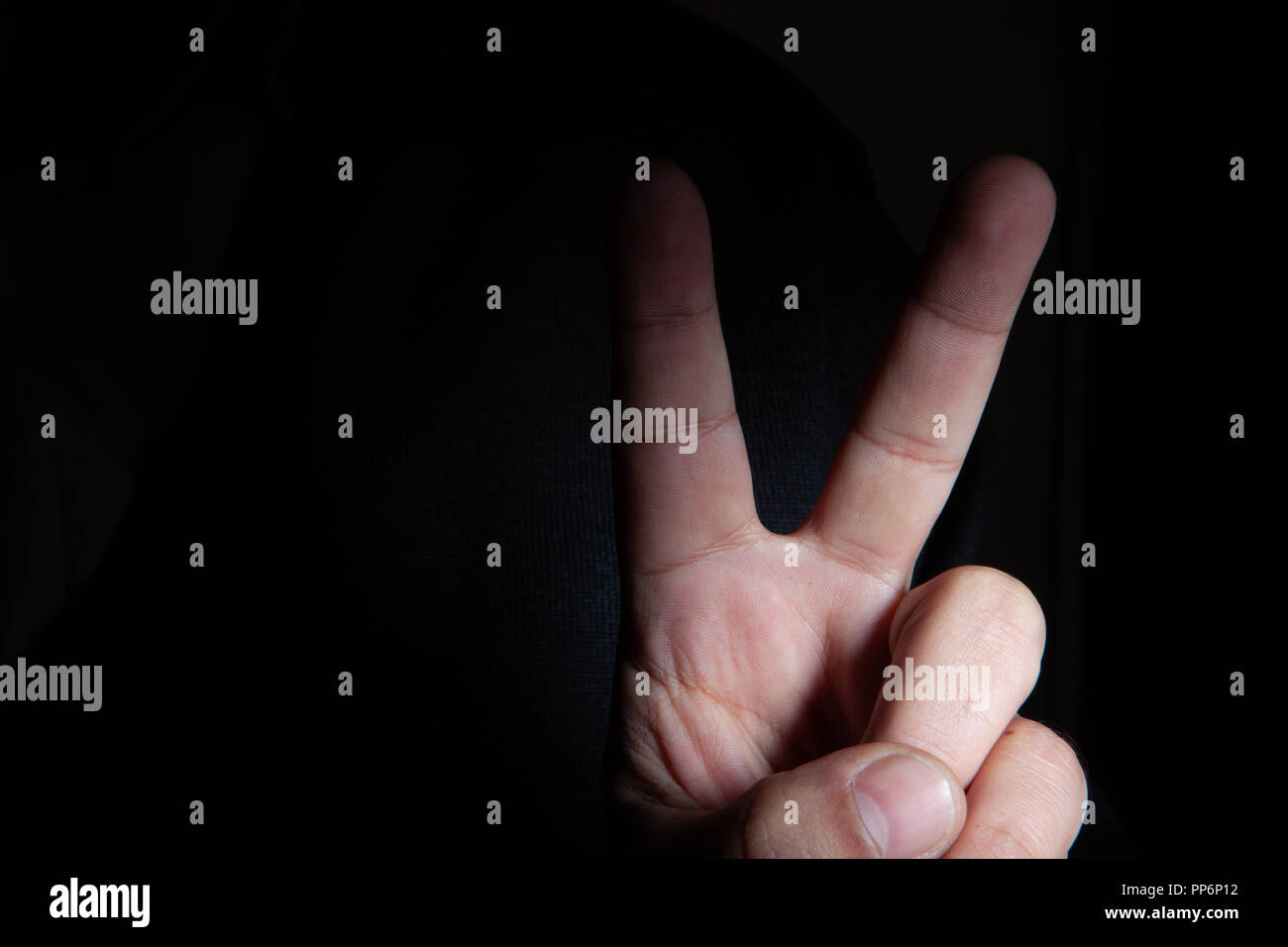 Human hand is drawn by light on a black background, power concept ...