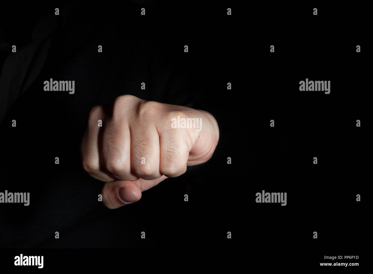 Human hand is drawn by light on a black background, power concept ...