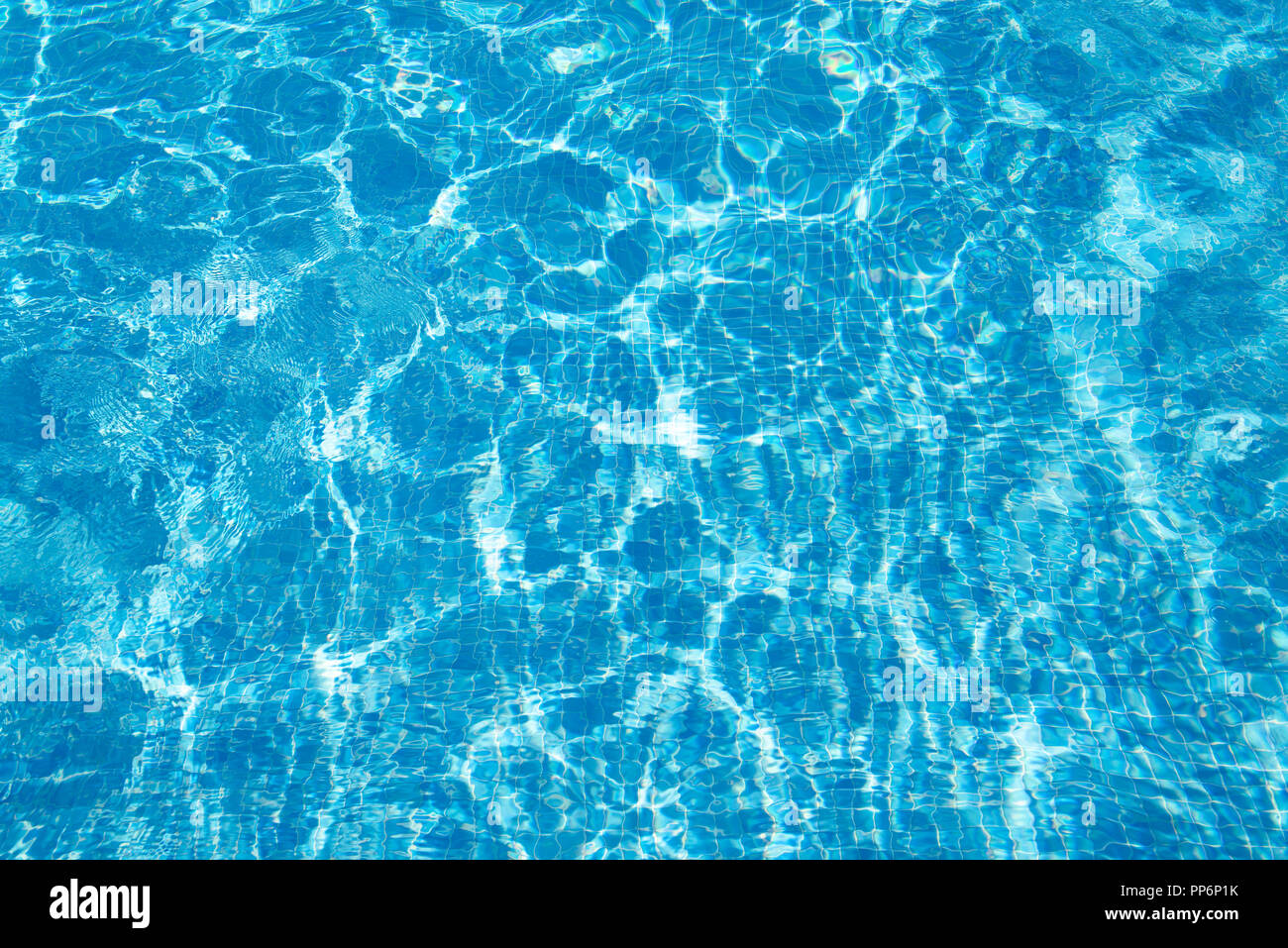 Blue swimming pool water with shiny sun reflections Stock Photo - Alamy