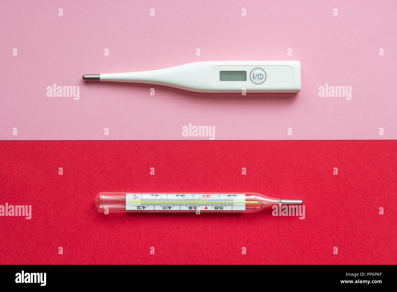 Old and modern thermometer on a pink and red background Stock Photo - Alamy