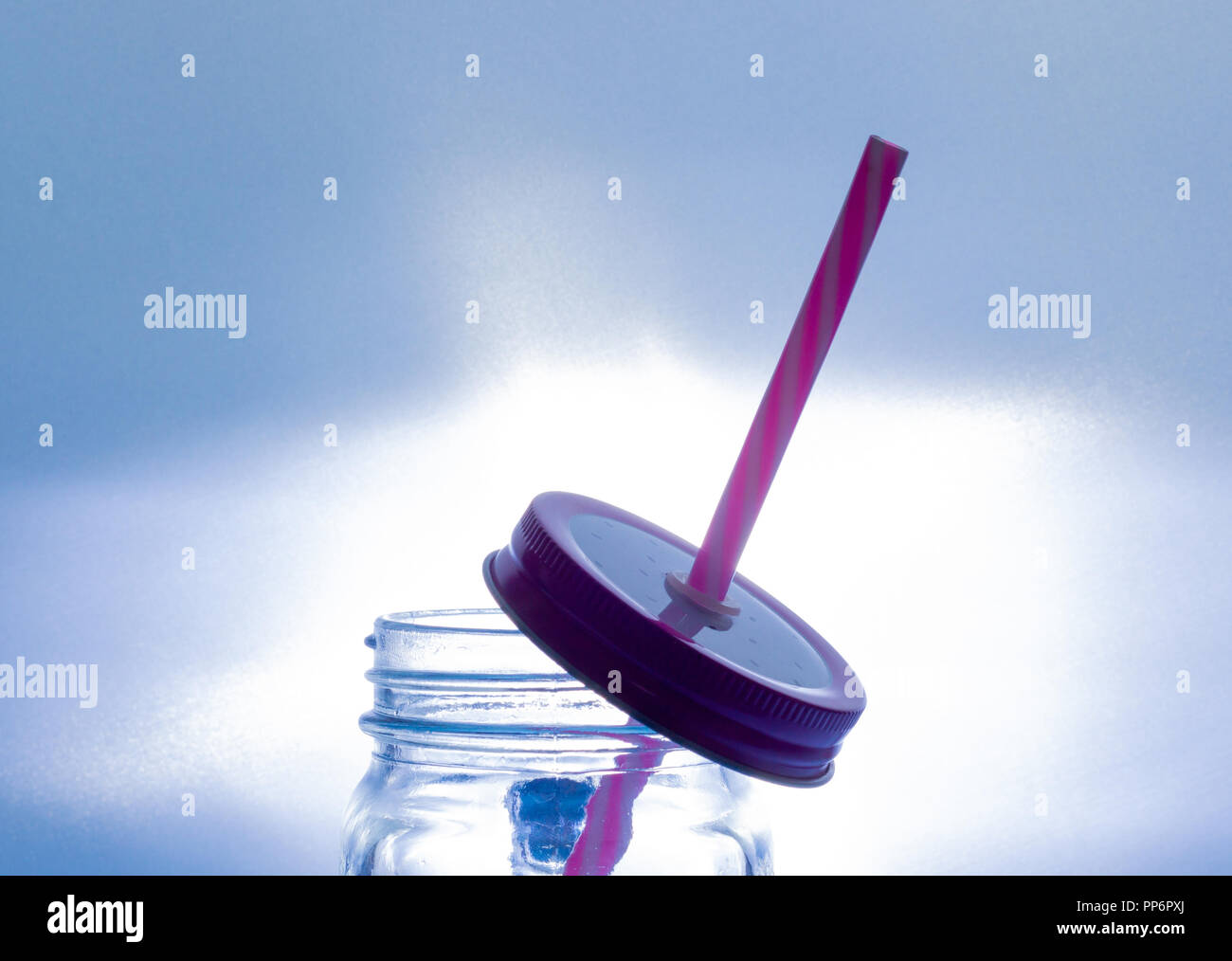Empty jar with straw and lid, lighted background Stock Photo - Alamy