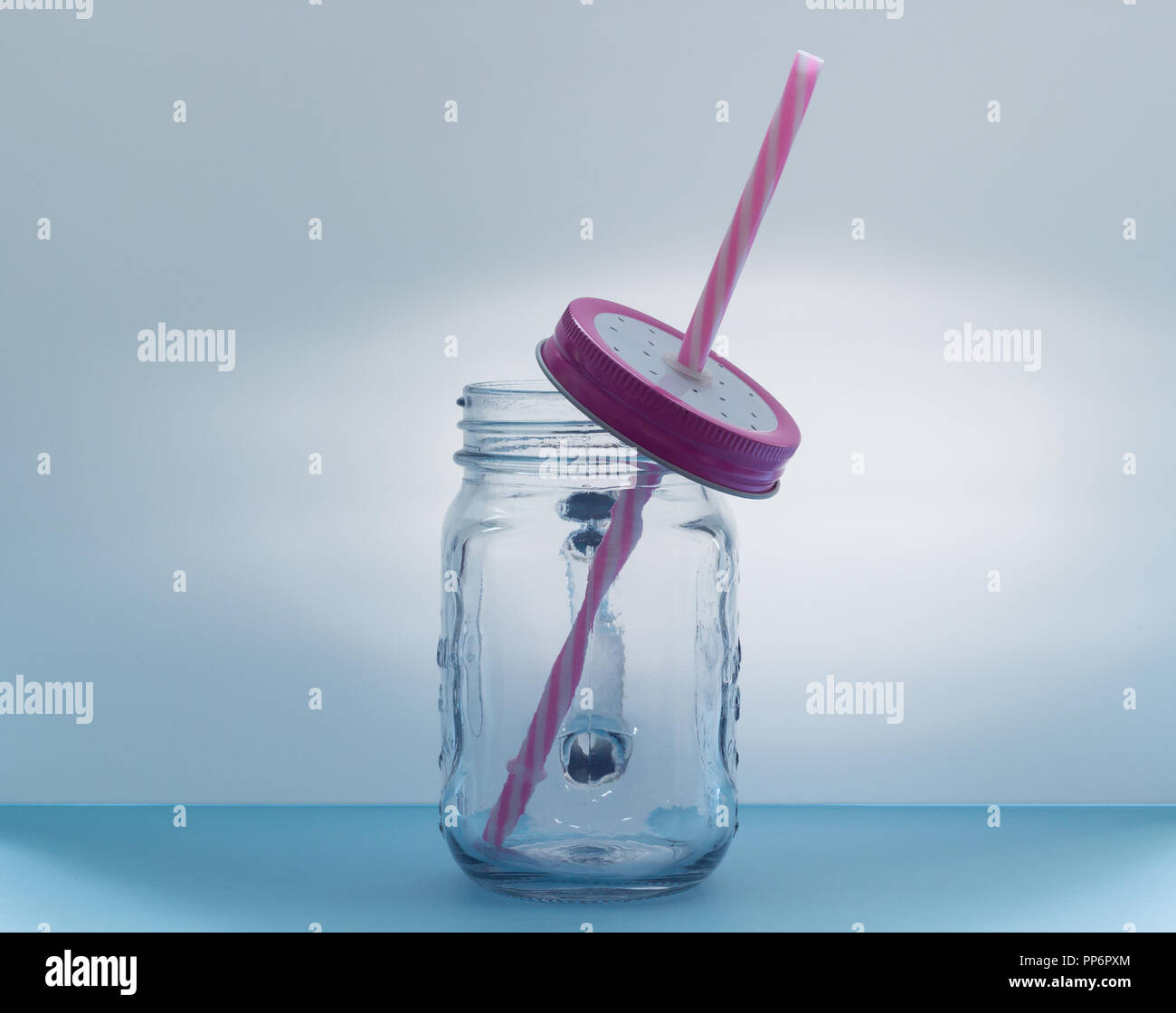 Empty vintage jar with straw and lid, lighted background Stock Photo ...