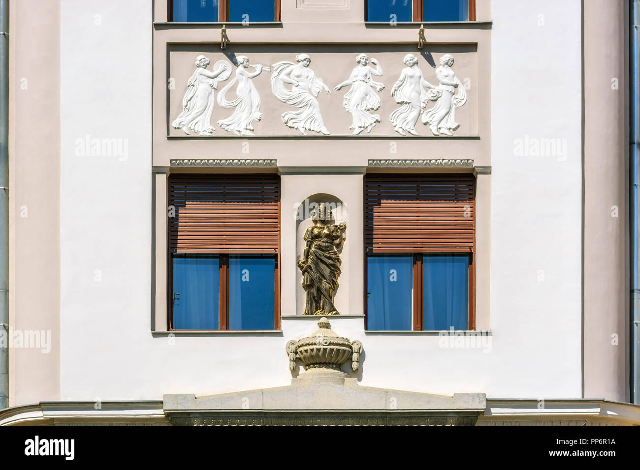 Two windows, half-closed with rolling shutters of brown color against a ...