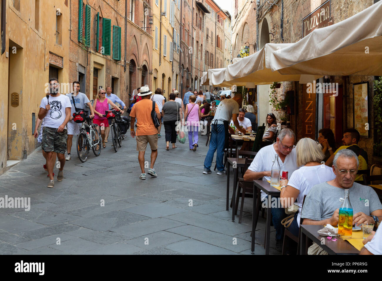Siena Italy - street scene, people walking the narrow streets of the ...