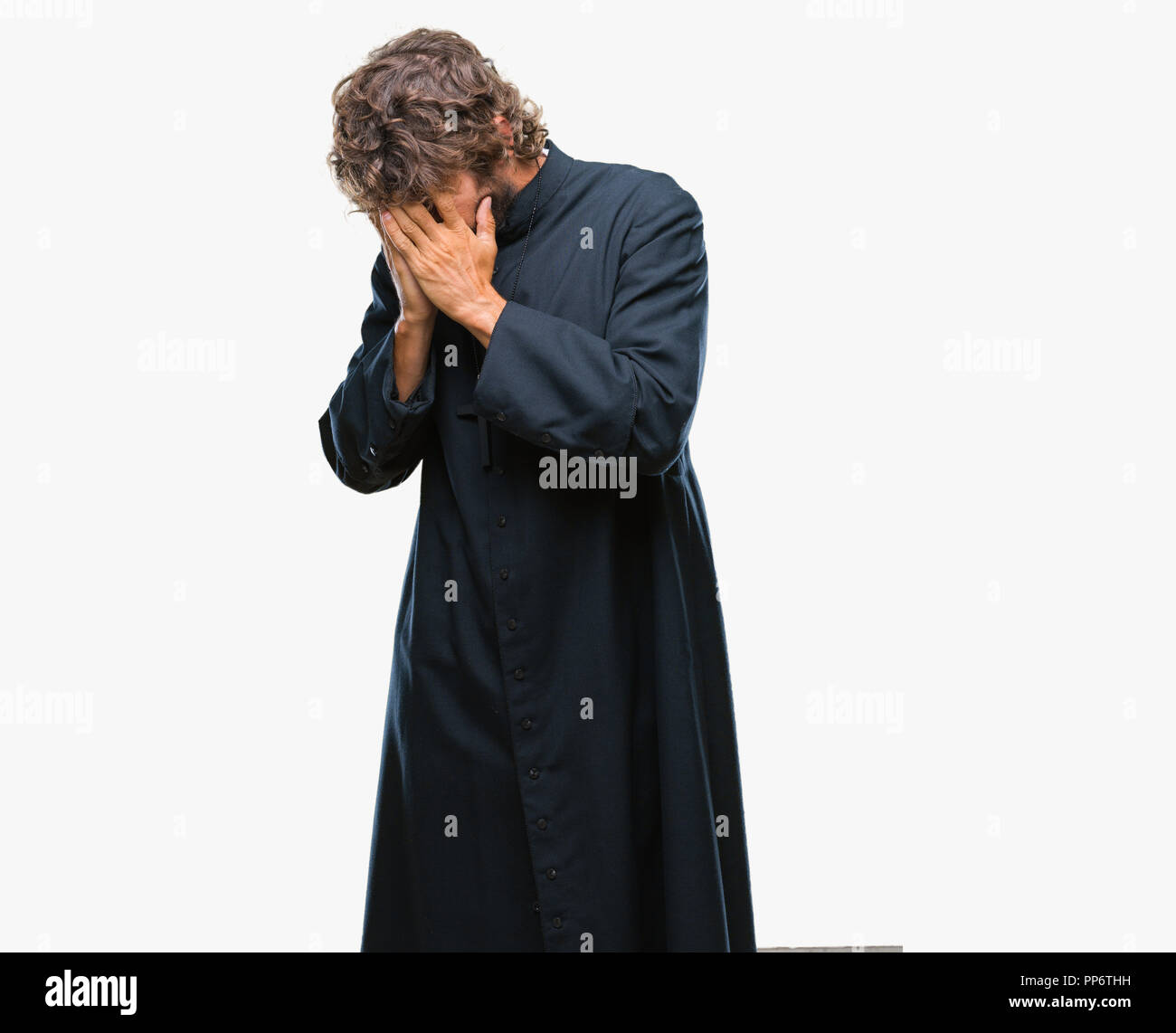 Handsome hispanic catholic priest man over isolated background with sad ...