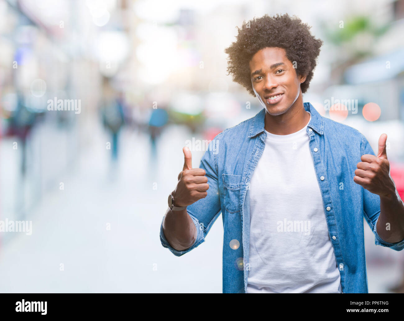 Afro american man over isolated background success sign doing positive ...