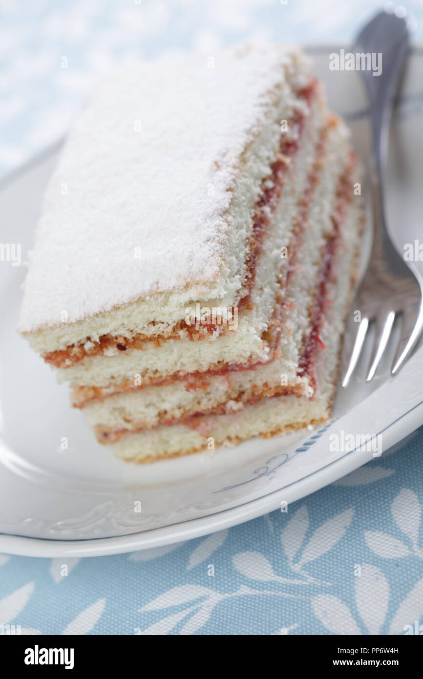 Slice of Victoria sponge cake on a plate Stock Photo - Alamy