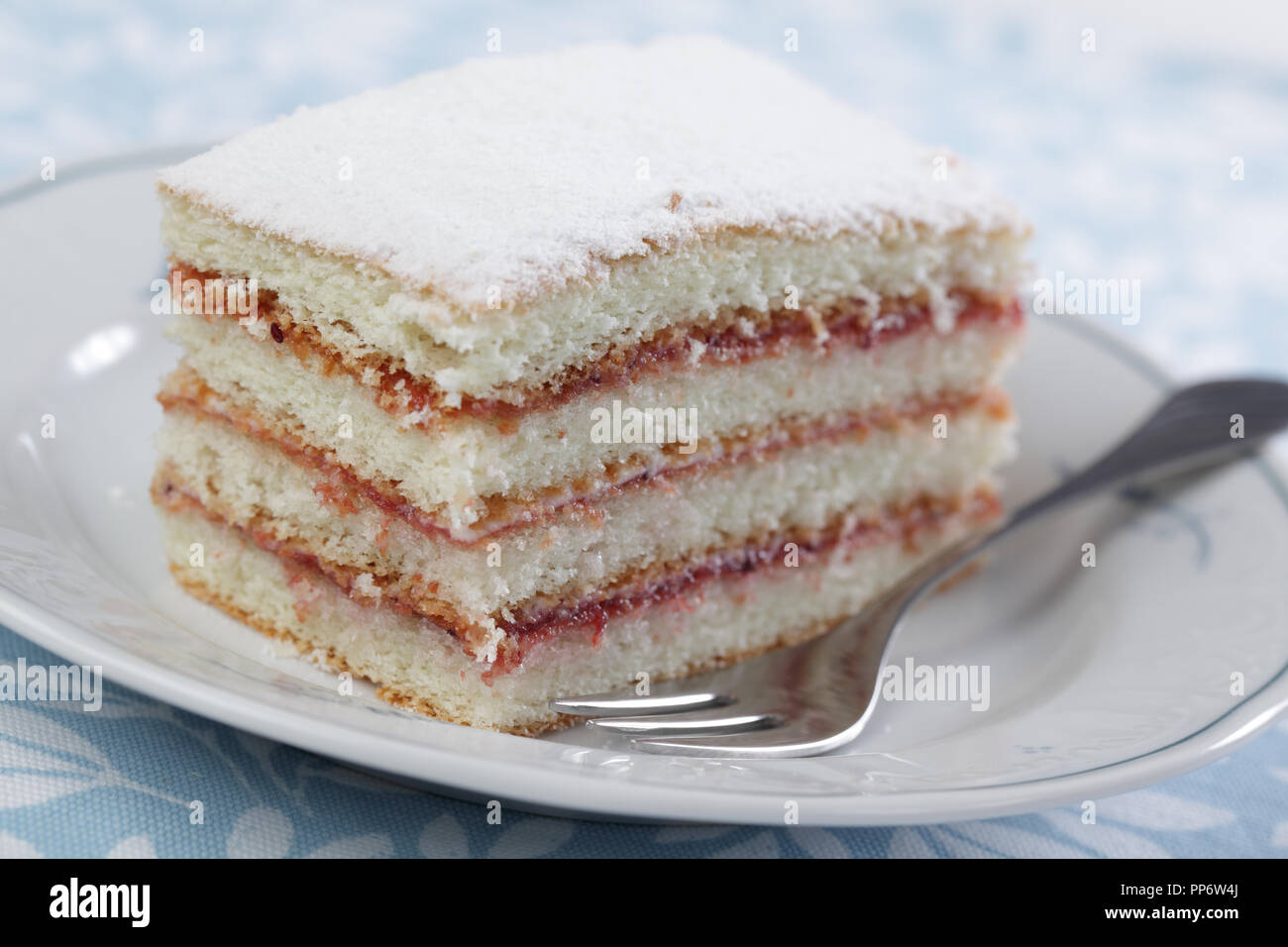 Slice of Victoria sponge cake on a plate Stock Photo - Alamy