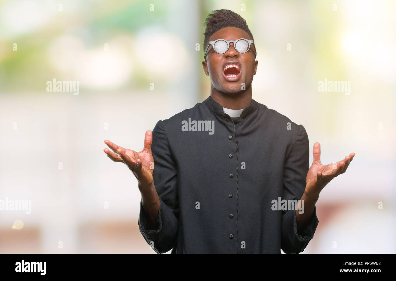 Young african american priest man over isolated background crazy and ...