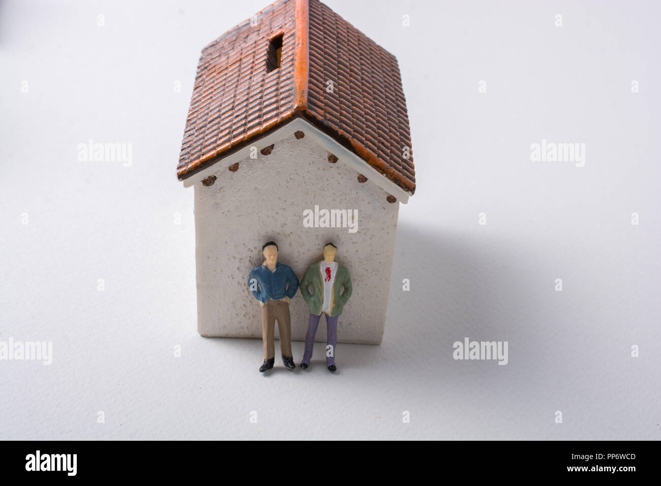 Tiny figurine of man miniature before a house Stock Photo - Alamy