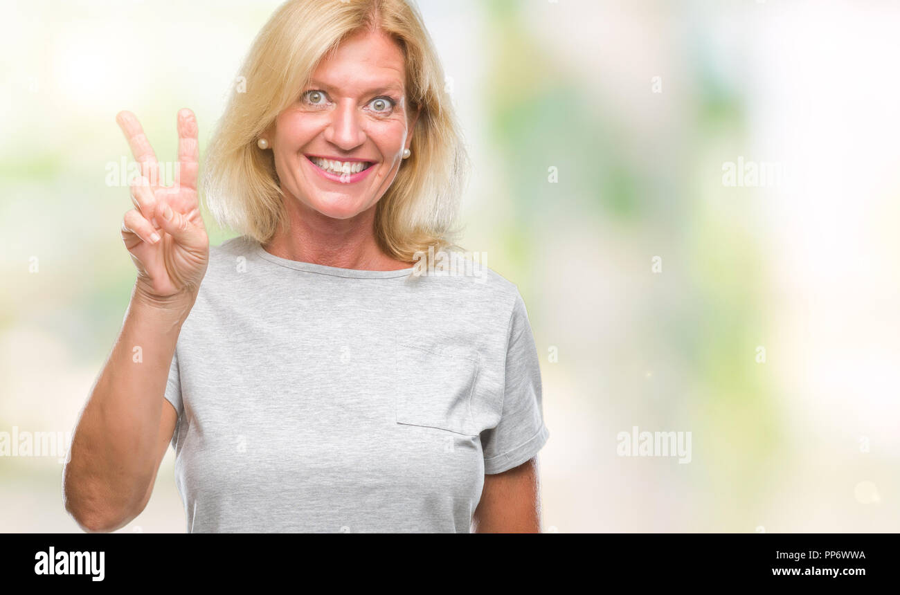 Middle age blonde woman over isolated background showing and pointing ...