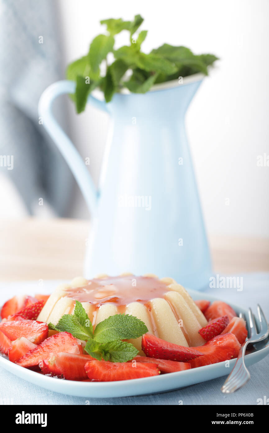 Semolina pudding with sliced strawberry, jam, and peppermint Stock ...