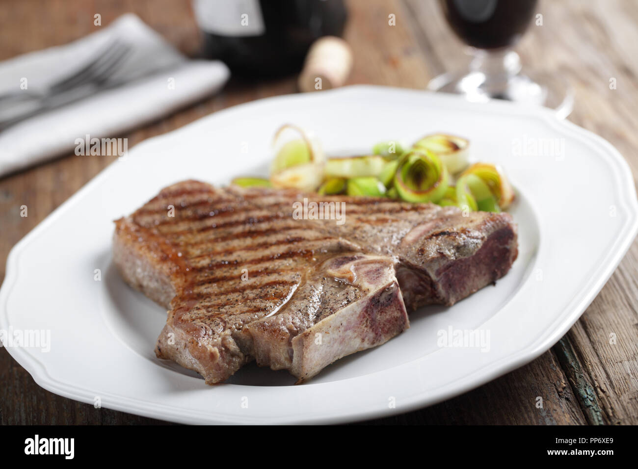 Medium rare T-bone steak with roasted leek and red wine Stock Photo - Alamy