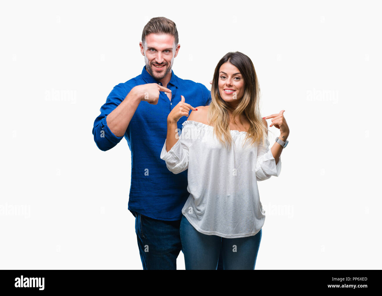 Young couple in love over isolated background looking confident with ...