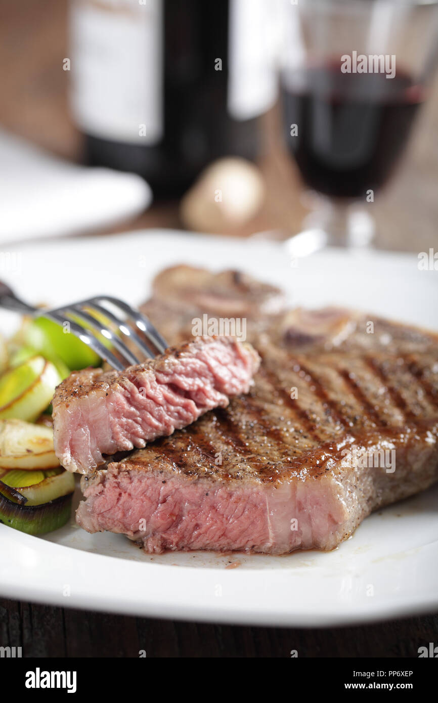 Medium rare T-bone steak with roasted leek and red wine Stock Photo - Alamy