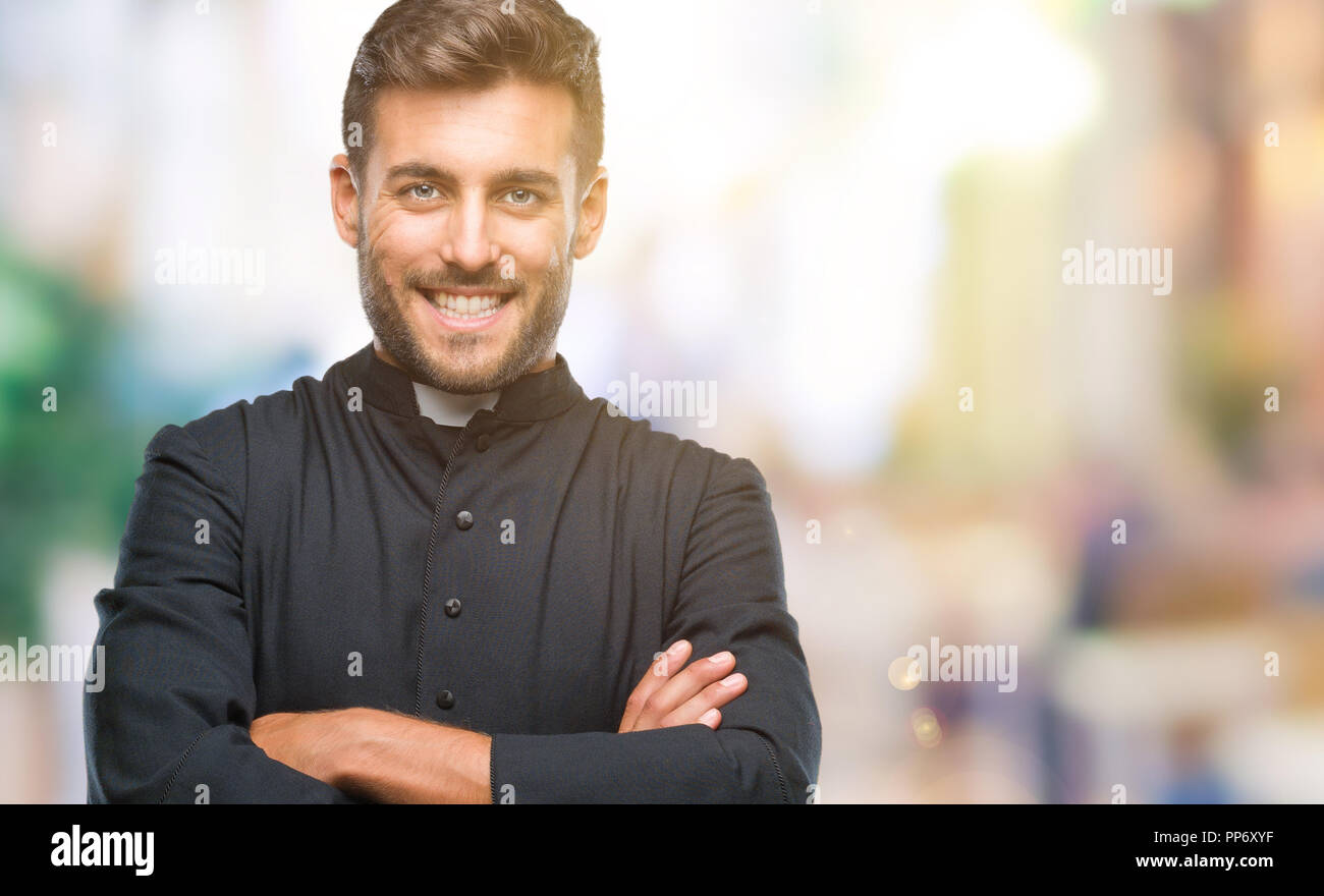 Young catholic christian priest man over isolated background happy face ...