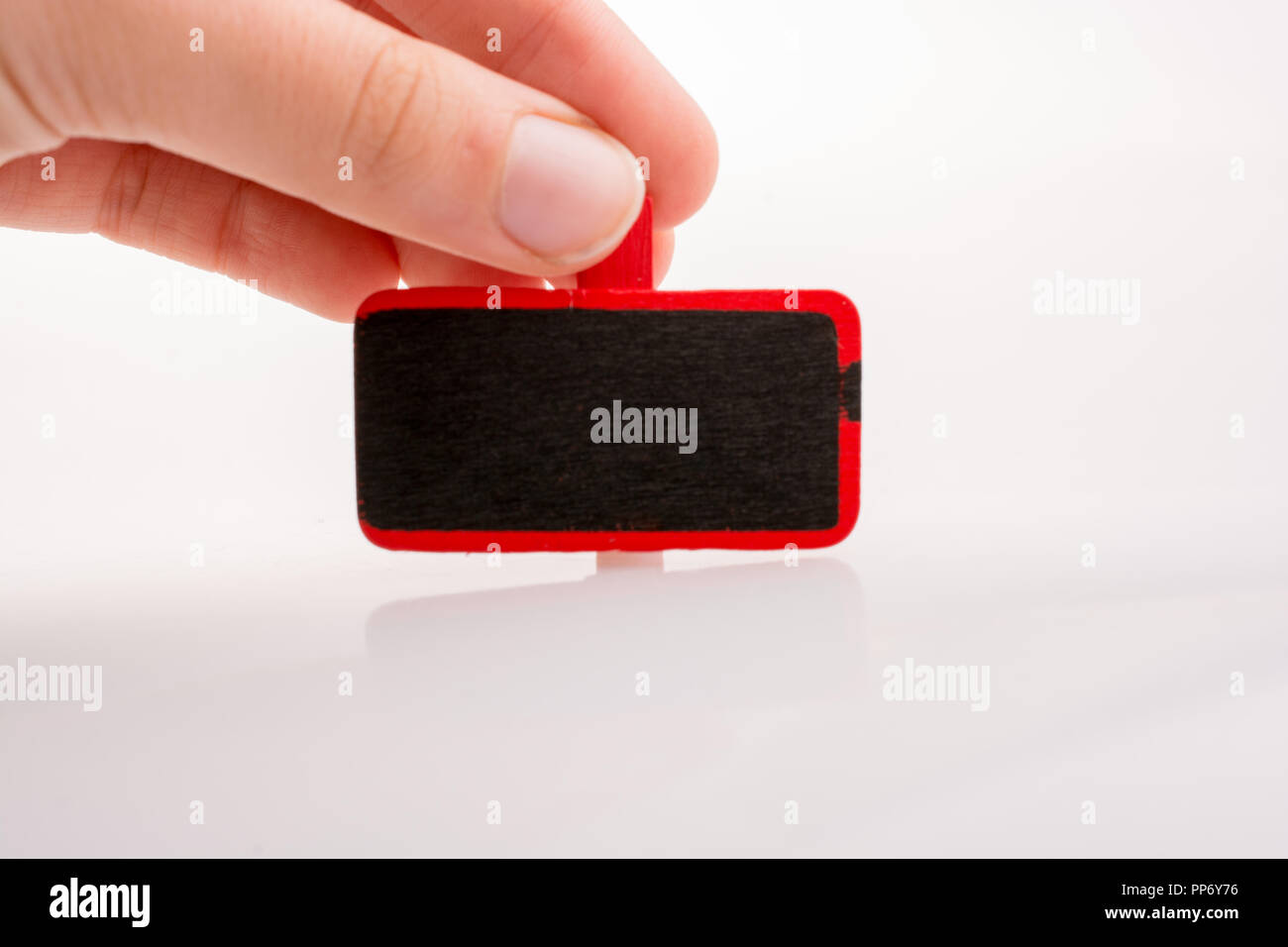 Hand holding a mini size notice board made of wood Stock Photo - Alamy