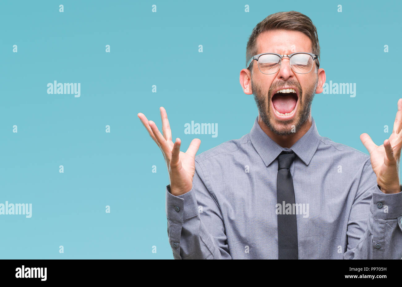 Young handsome business man over isolated background celebrating mad and crazy for success with ...