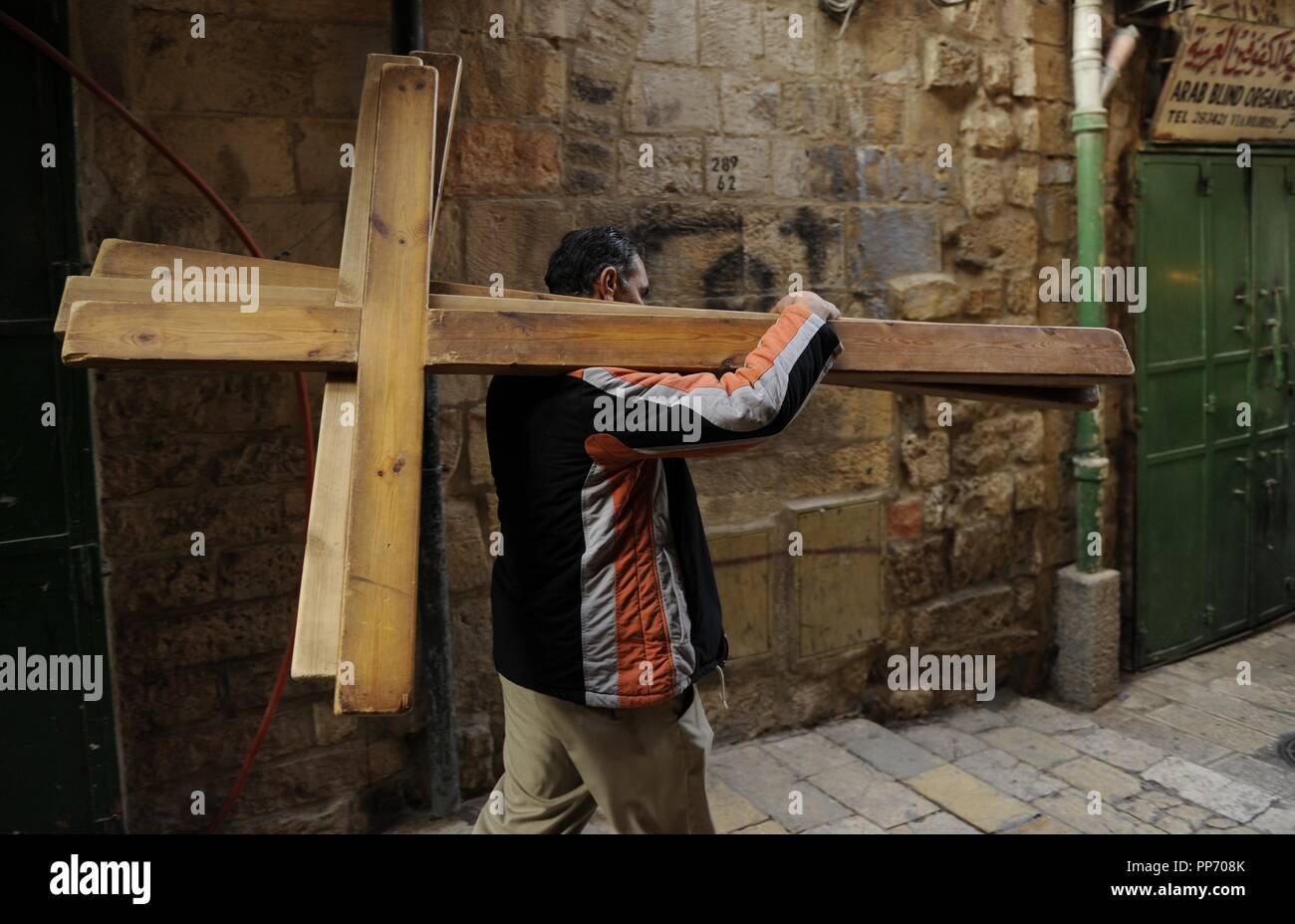 Israel. Jerusalem. Man carrying wooden crosses along the Via Dolorosa ...