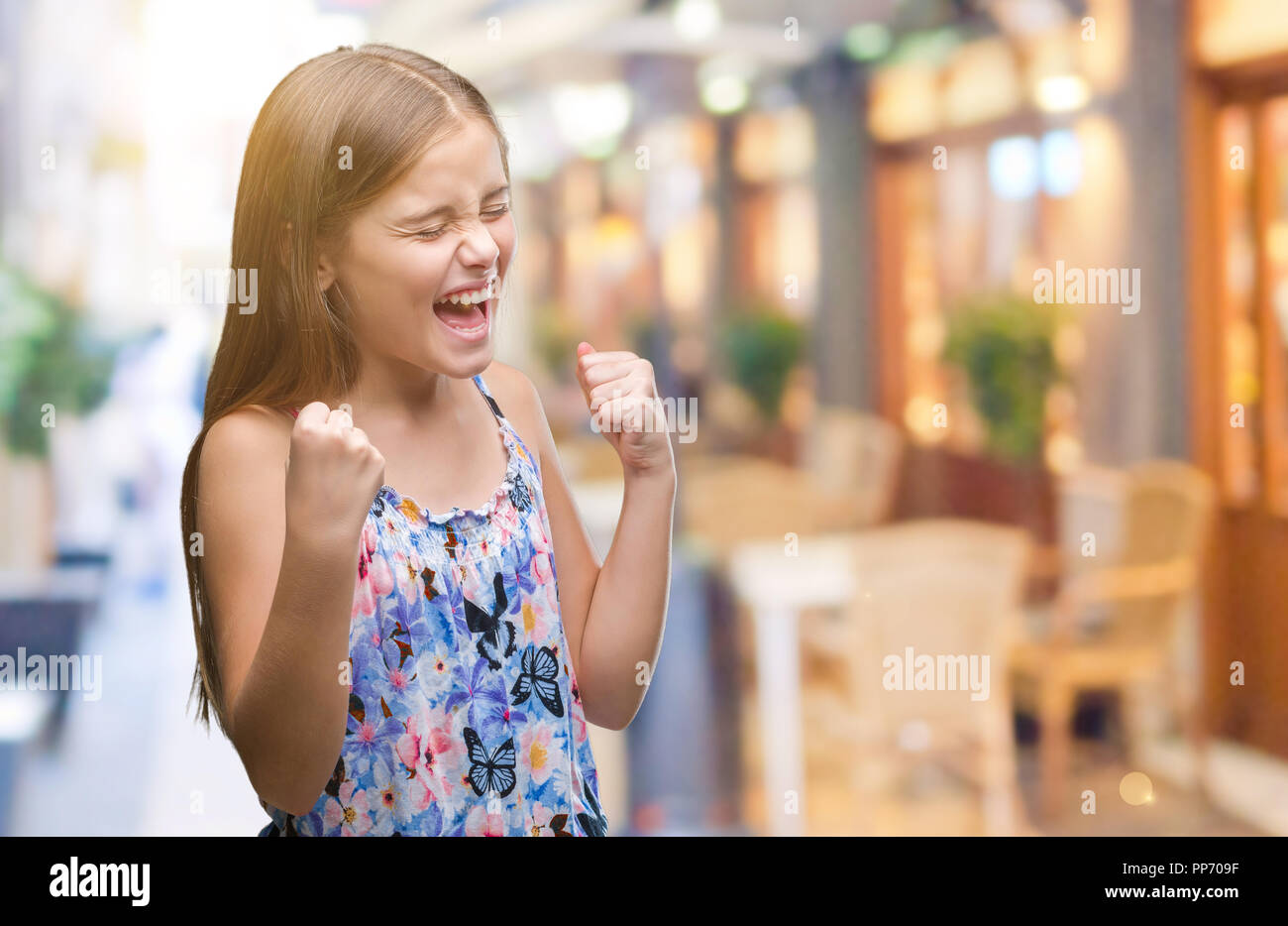 Young beautiful girl wearing colorful dress over isolated background ...