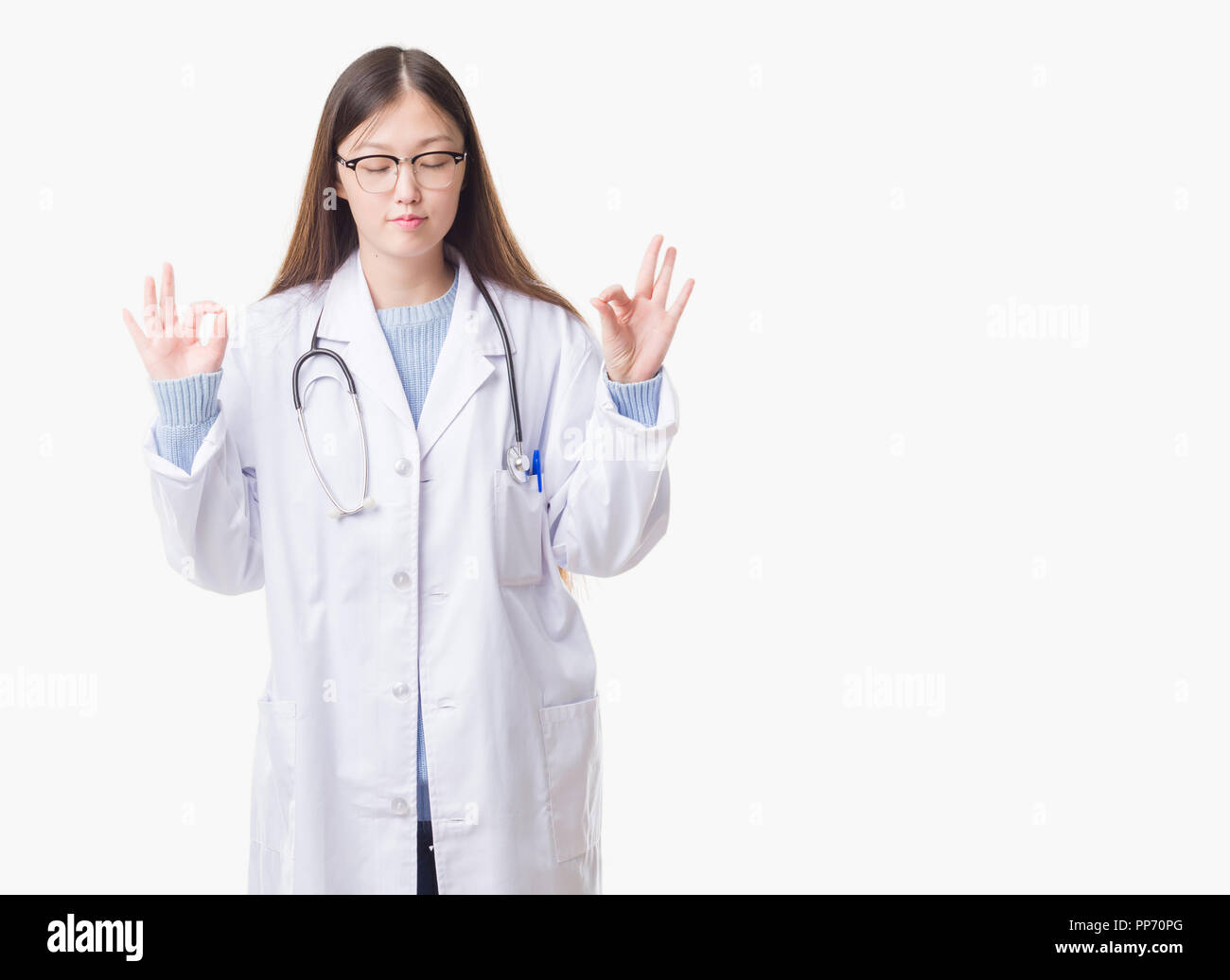 Young Chinese doctor woman over isolated background relax and smiling ...