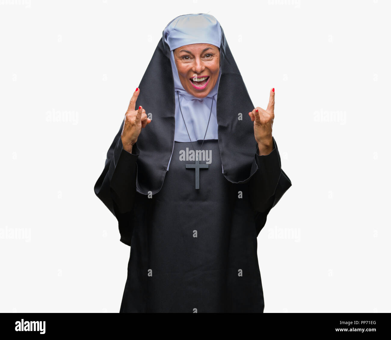 Middle age senior christian catholic nun woman over isolated background ...