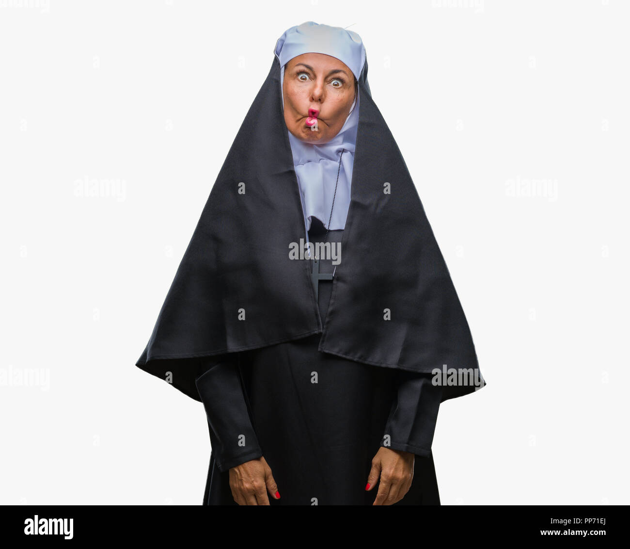 Middle age senior christian catholic nun woman over isolated background ...
