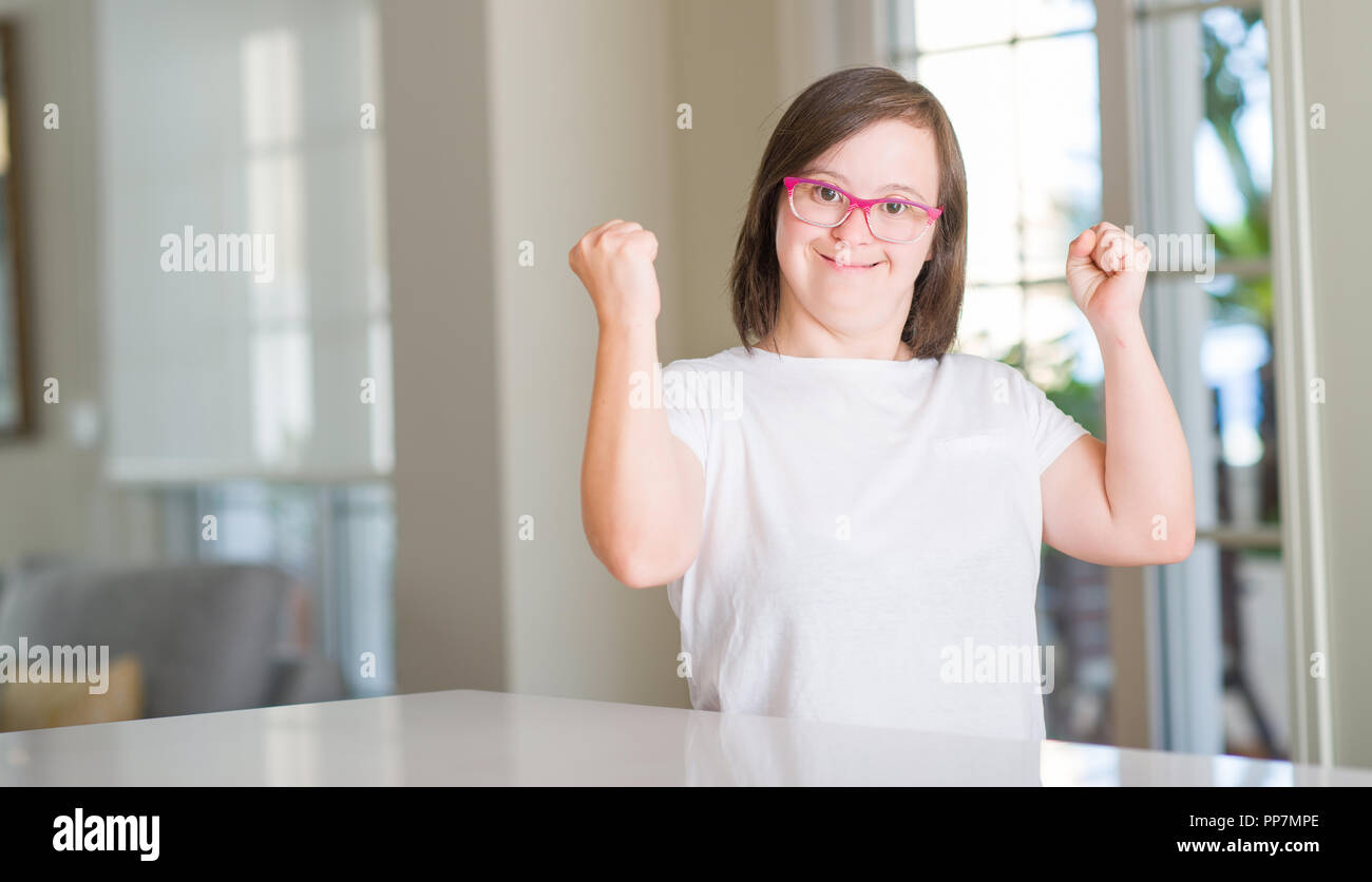 Down syndrome woman at home screaming proud and celebrating victory and ...