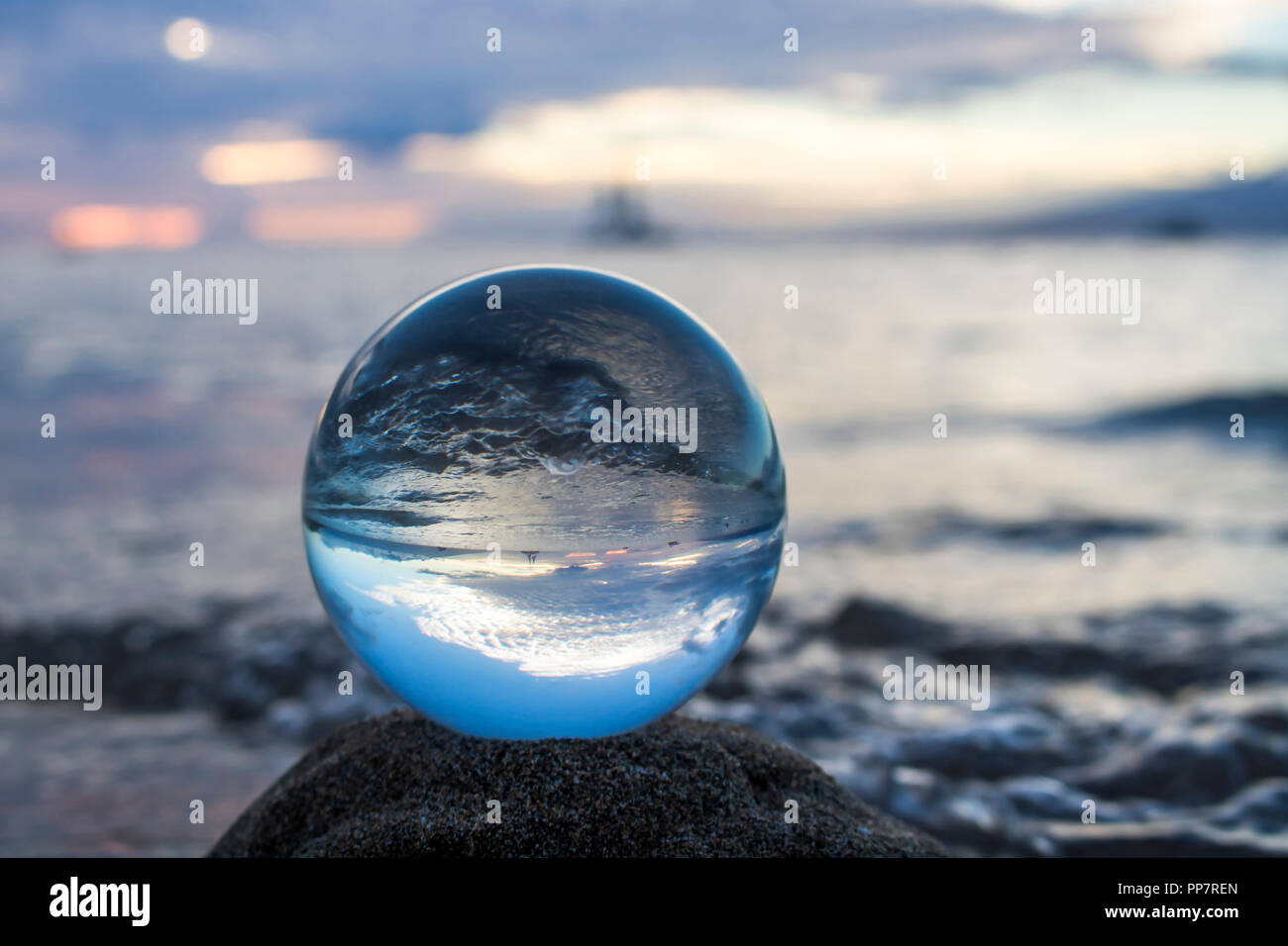 Ocean Surface with Wave and Beach Captured in Reflection in Glass Ball ...