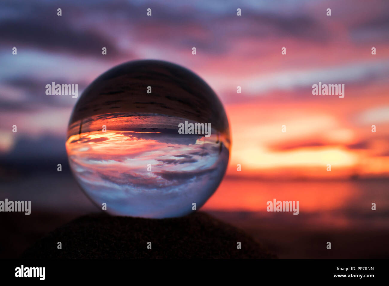 Sunset Seascape Captured in Reflection in Glass Ball Stock Photo - Alamy