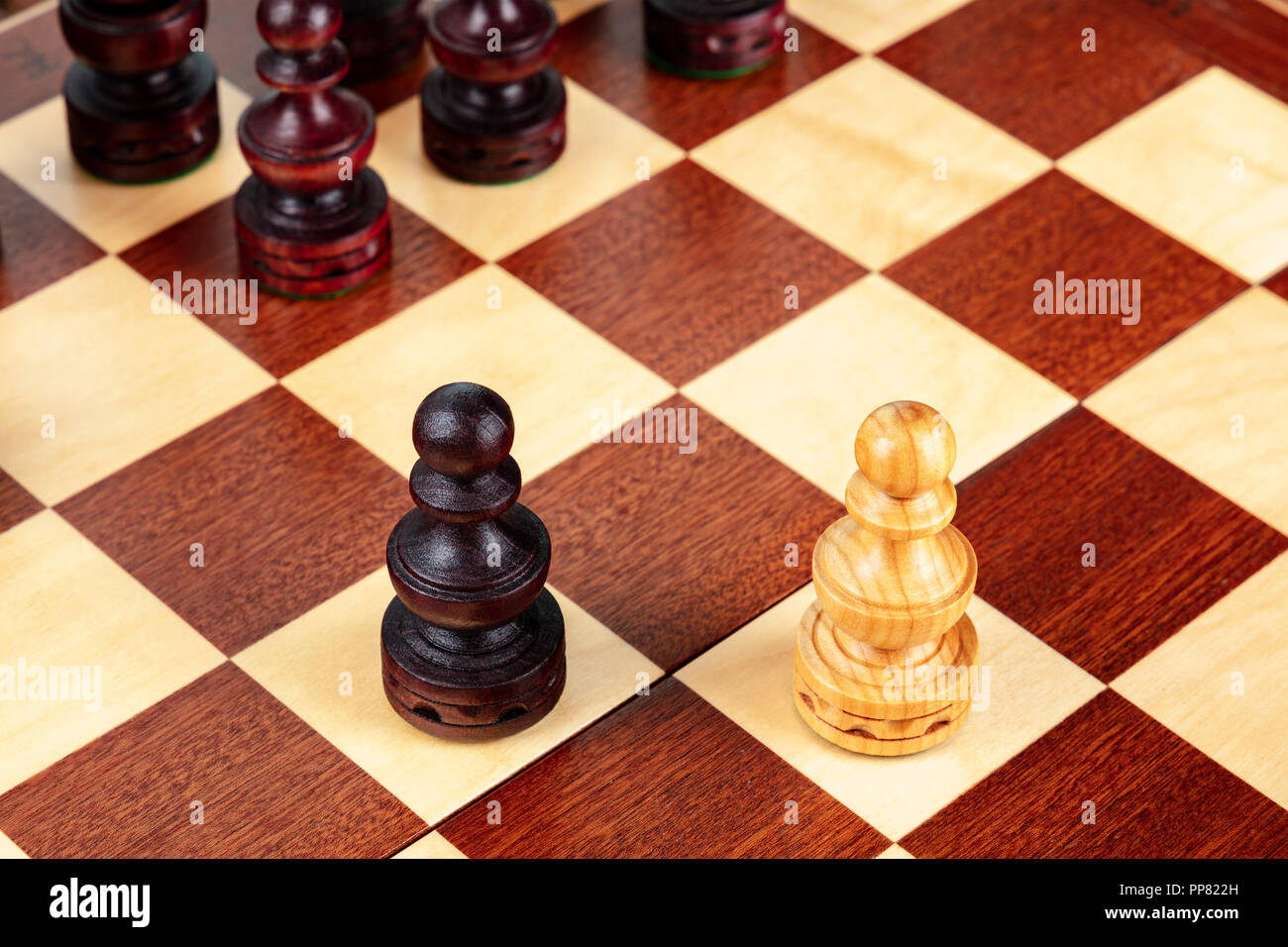 Two pawns on a chessboard, a metaphor for a conflict or a challenge ...