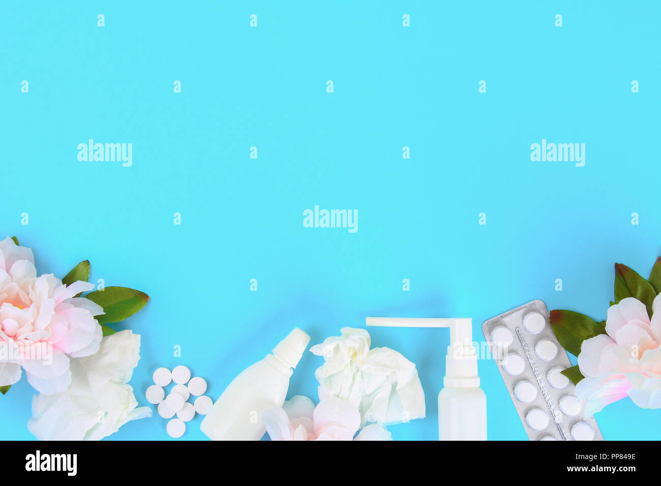 Medicines for flu, illness, cold, cough against a blue table with ...