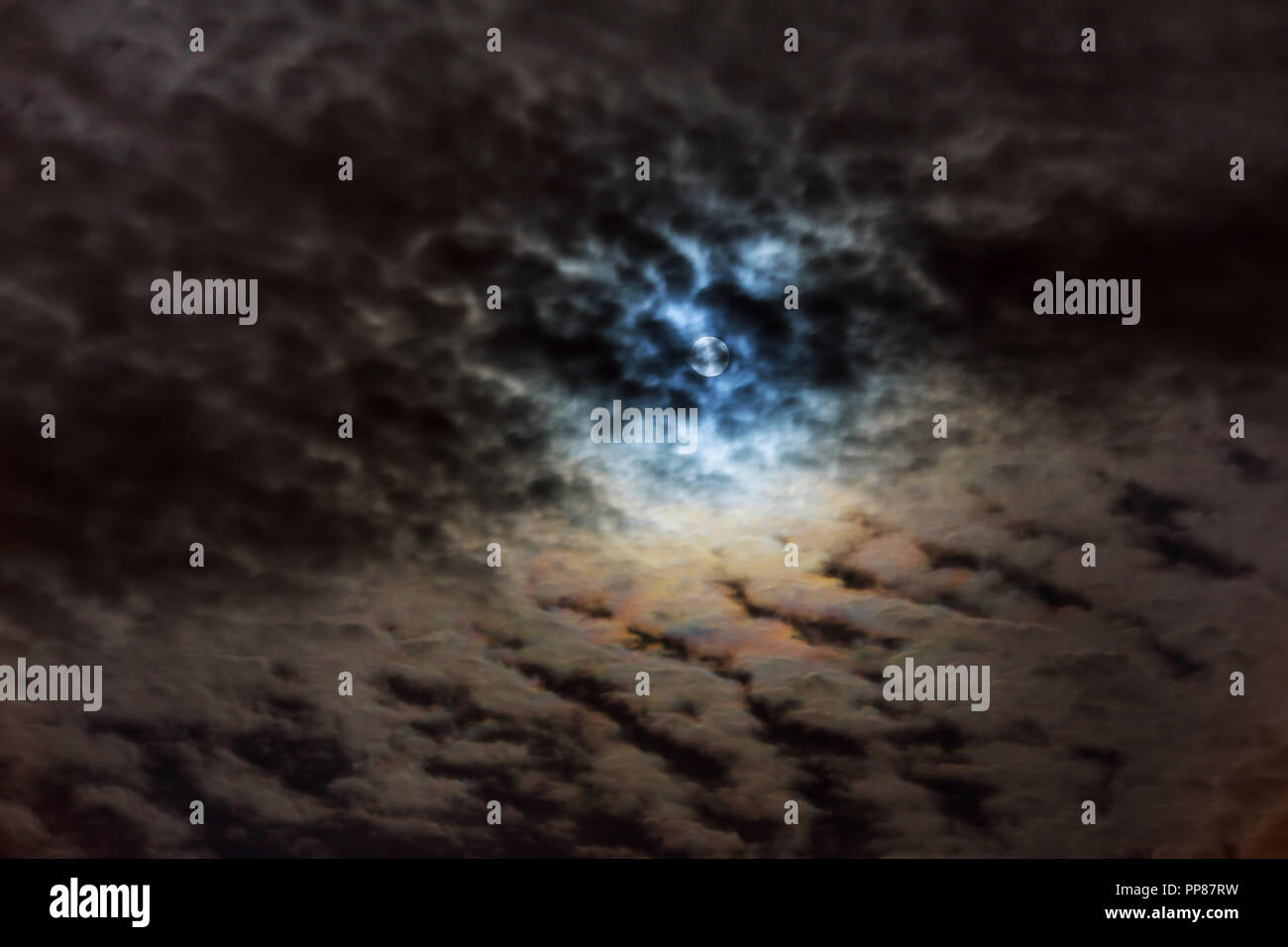 Dramatic clouds in the mysterious night sky with full moon in the ...