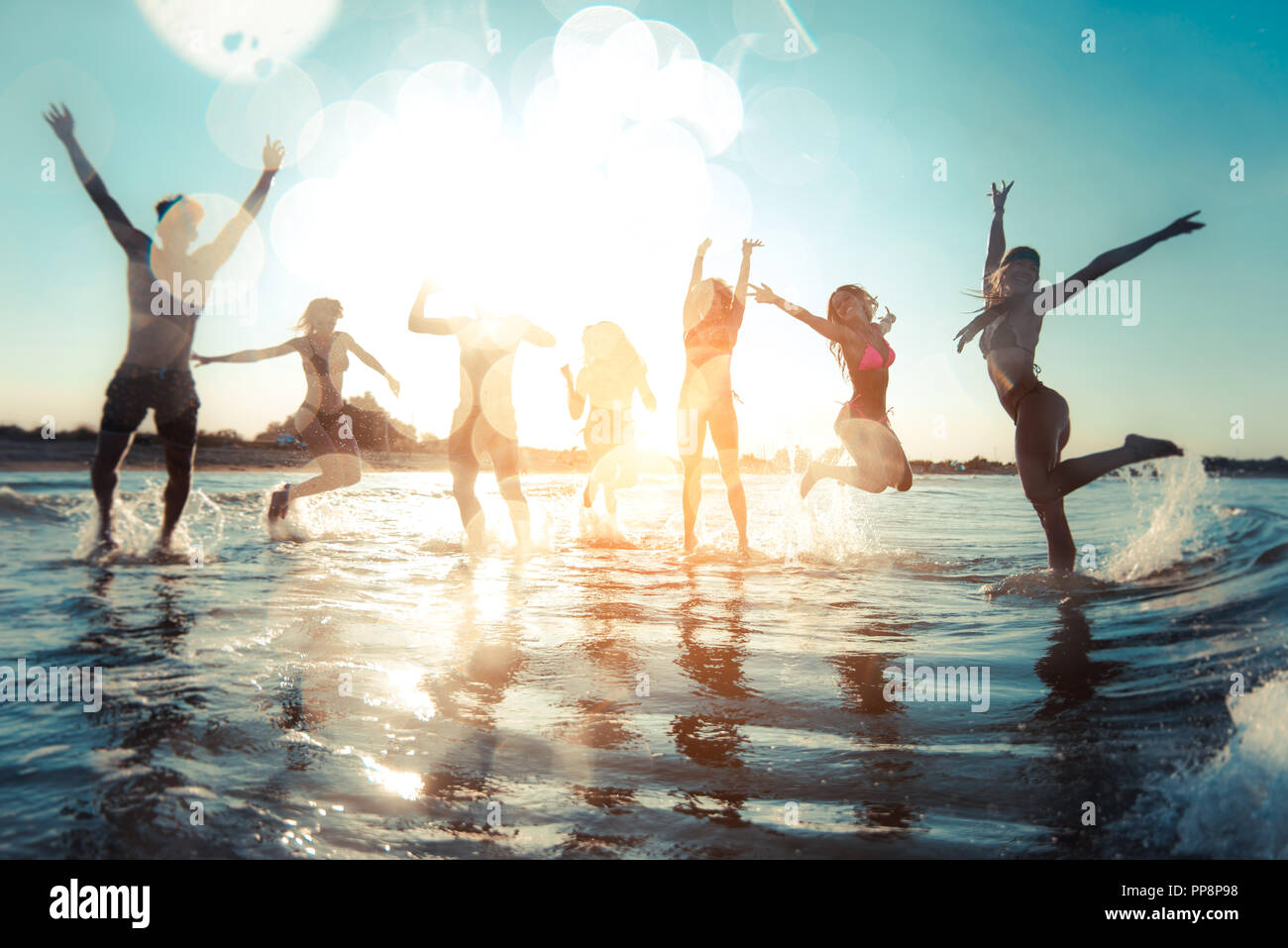 Group of friends having fun at the sea - Happy young people on a summer ...