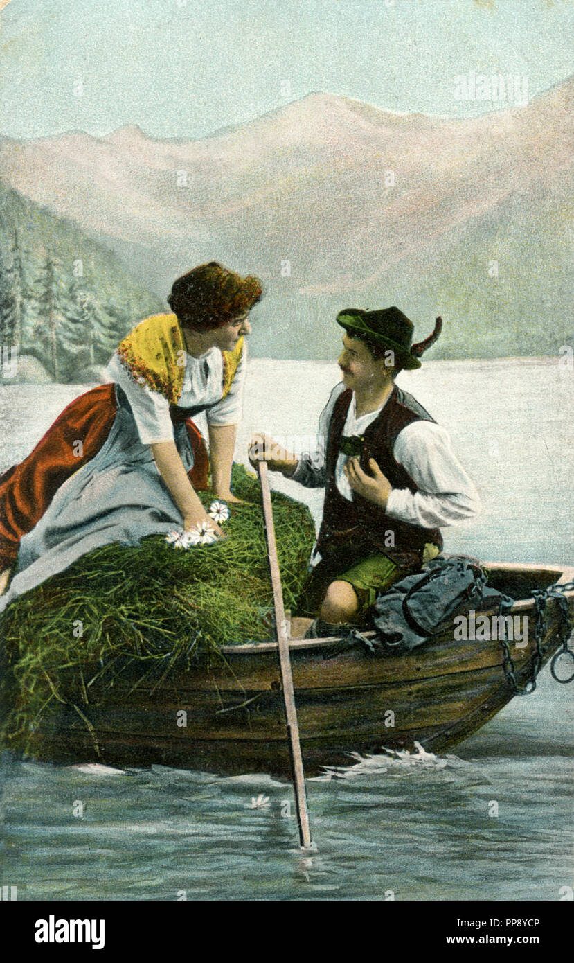 Bavarian couple in a boat Stock Photo - Alamy