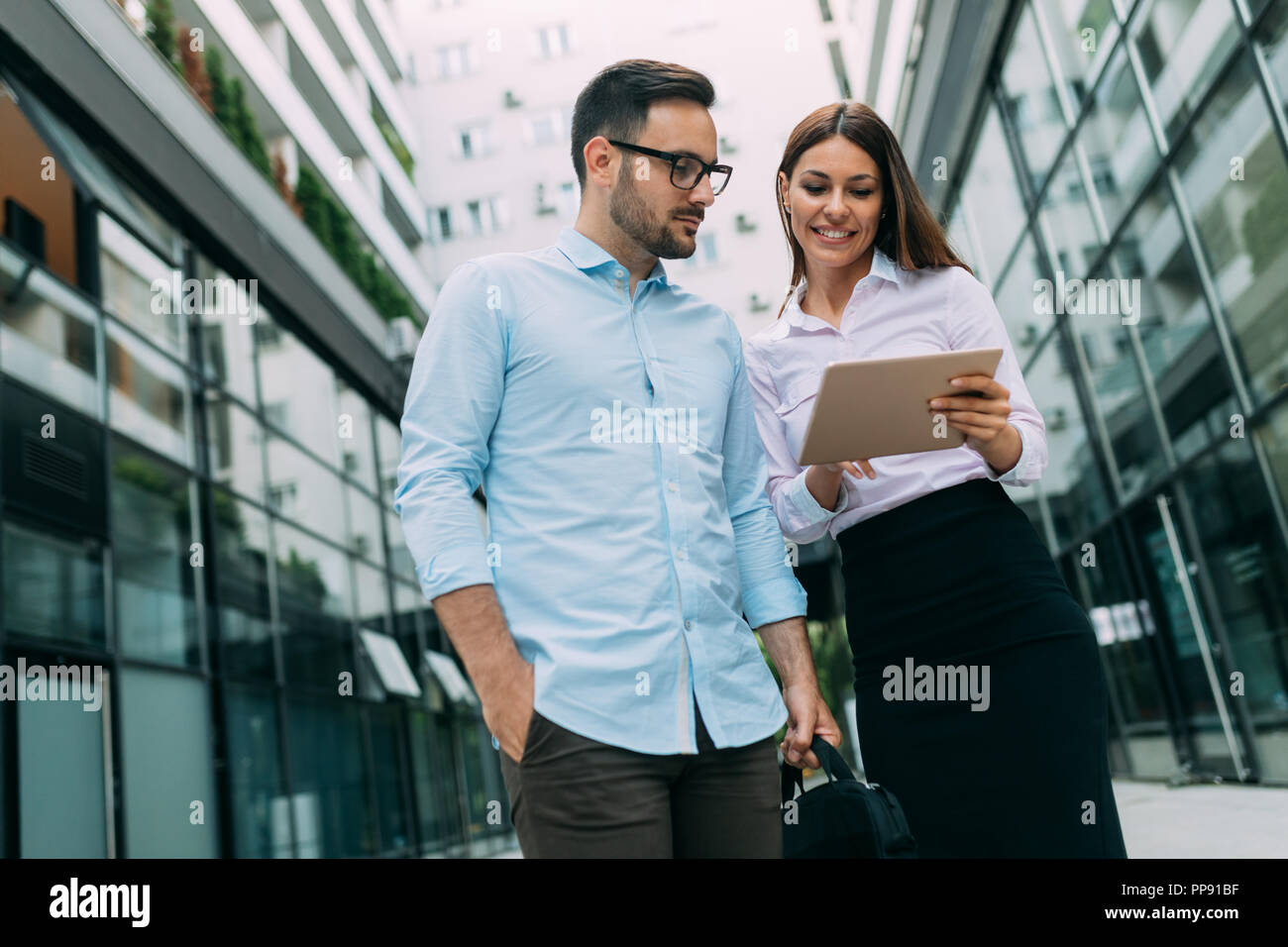 Picture of handsome man and beautiful woman as business partners Stock ...