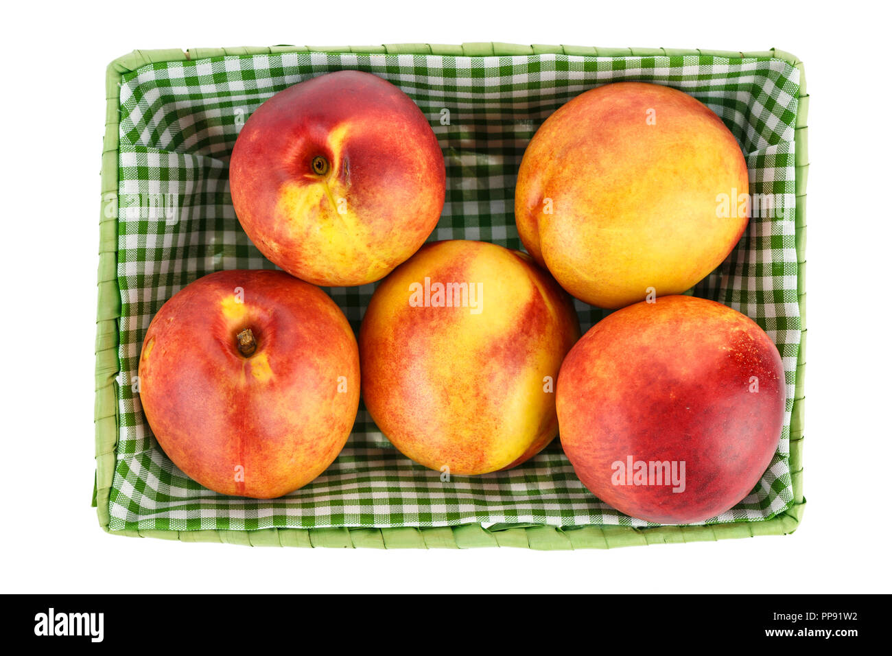 ripe organic nectarines in a plate on a white background. isolated ...