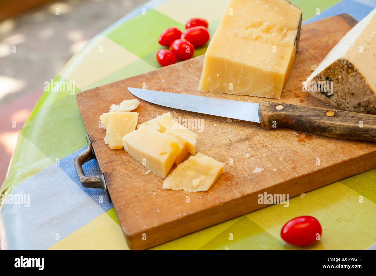 Pecorino sardo cheese slices on wooden board with knife Stock Photo - Alamy