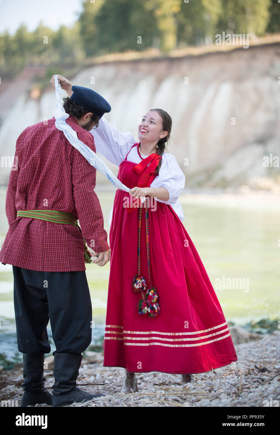 A couple dancing folk dances in Russian national costumes Stock Photo ...
