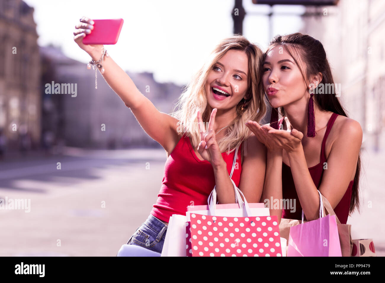 Joyful positive young women posing for their photo Stock Photo - Alamy