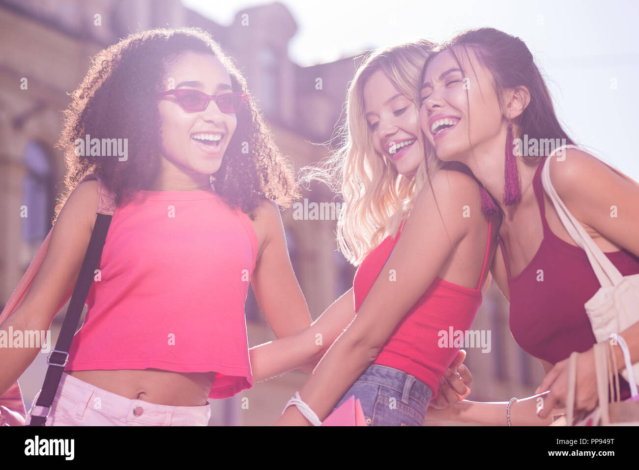 Delighted nice young women showing their positive emotions Stock Photo ...