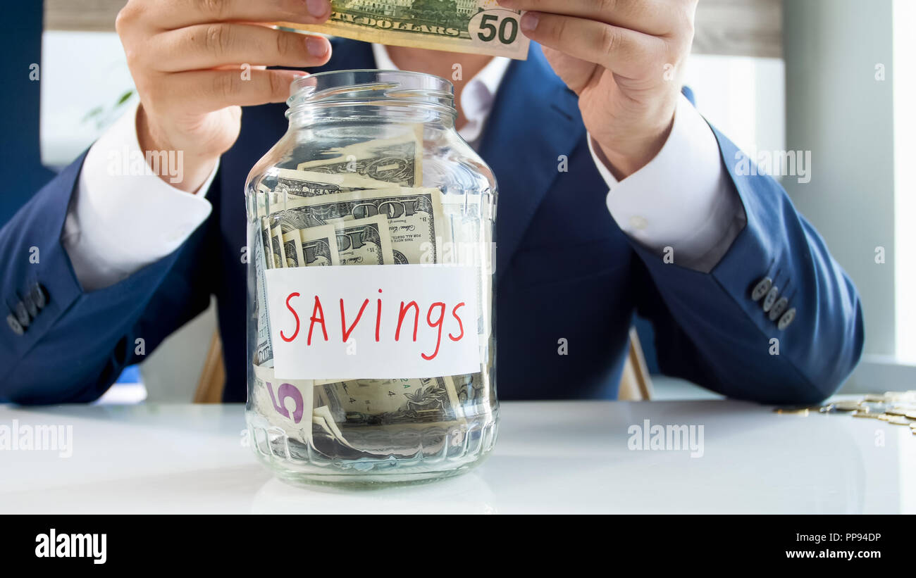 Closeup photo of successful businessman filling and growing his money ...