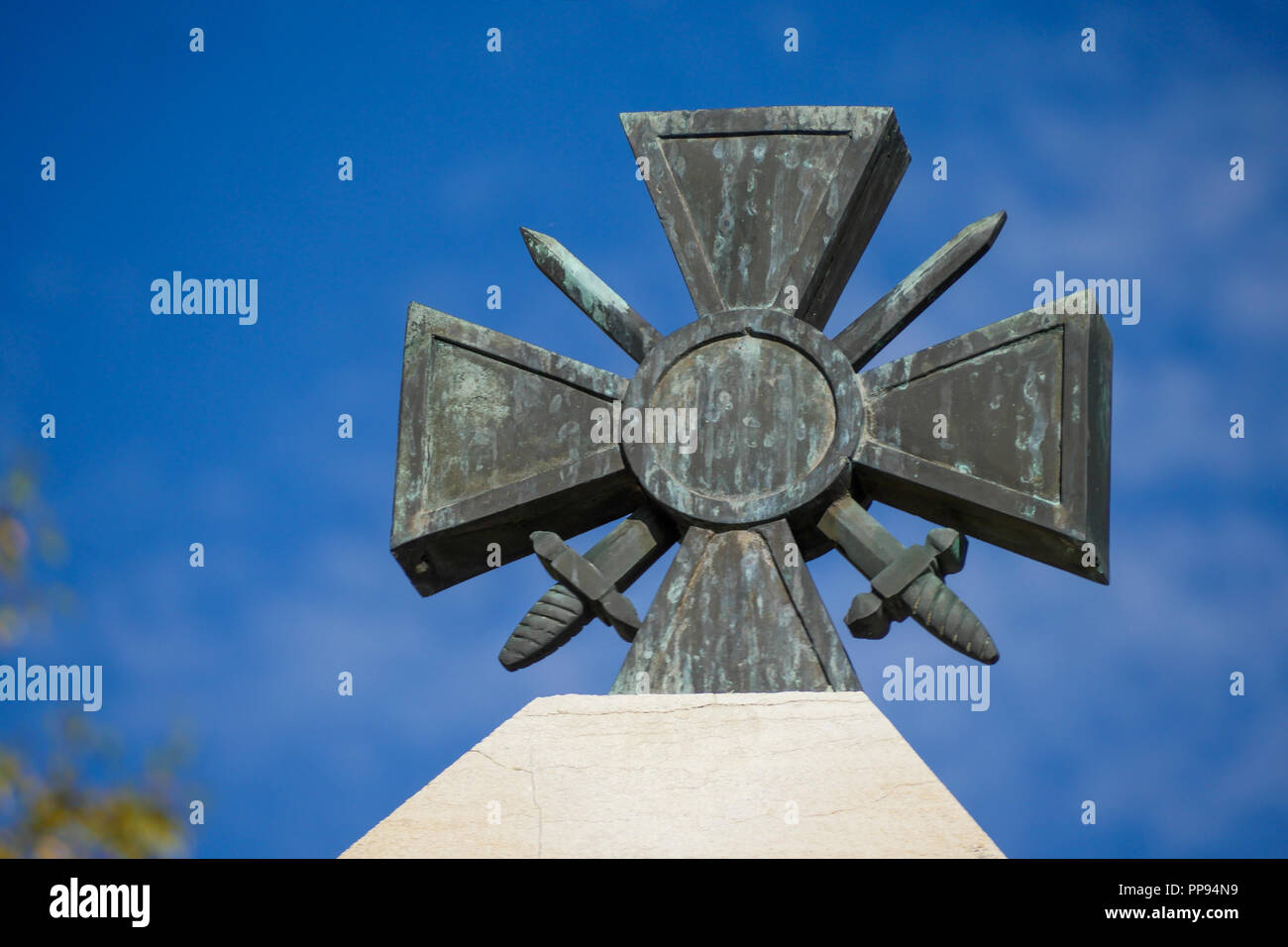 Military cross on top of the War memorial, Saint-Hugues de Chartreuse ...