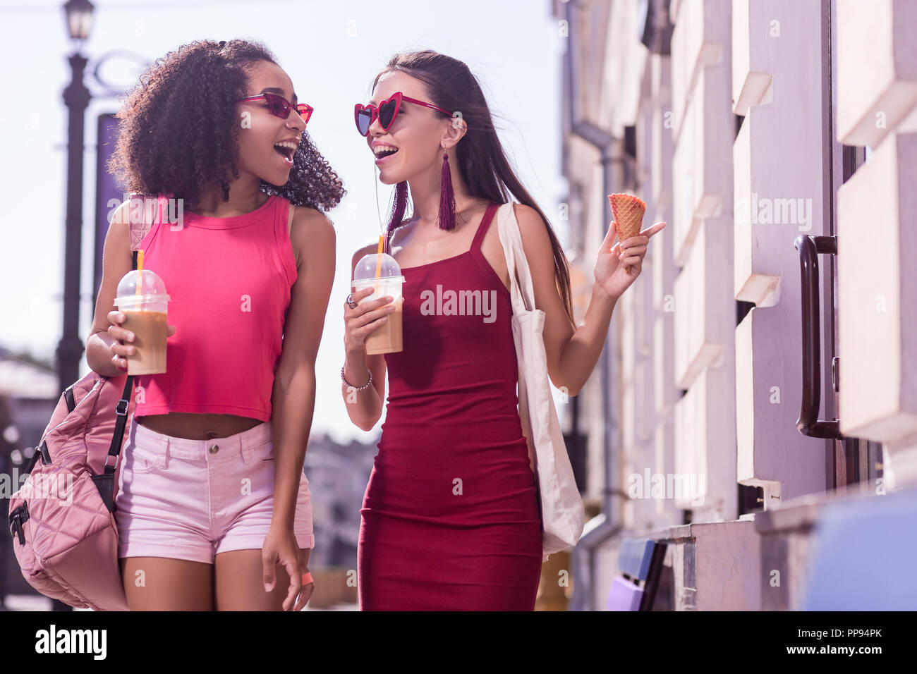 Joyful positive woman pointing at the shop window Stock Photo - Alamy