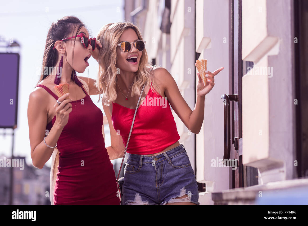 Happy joyful women standing in front of the shop Stock Photo - Alamy