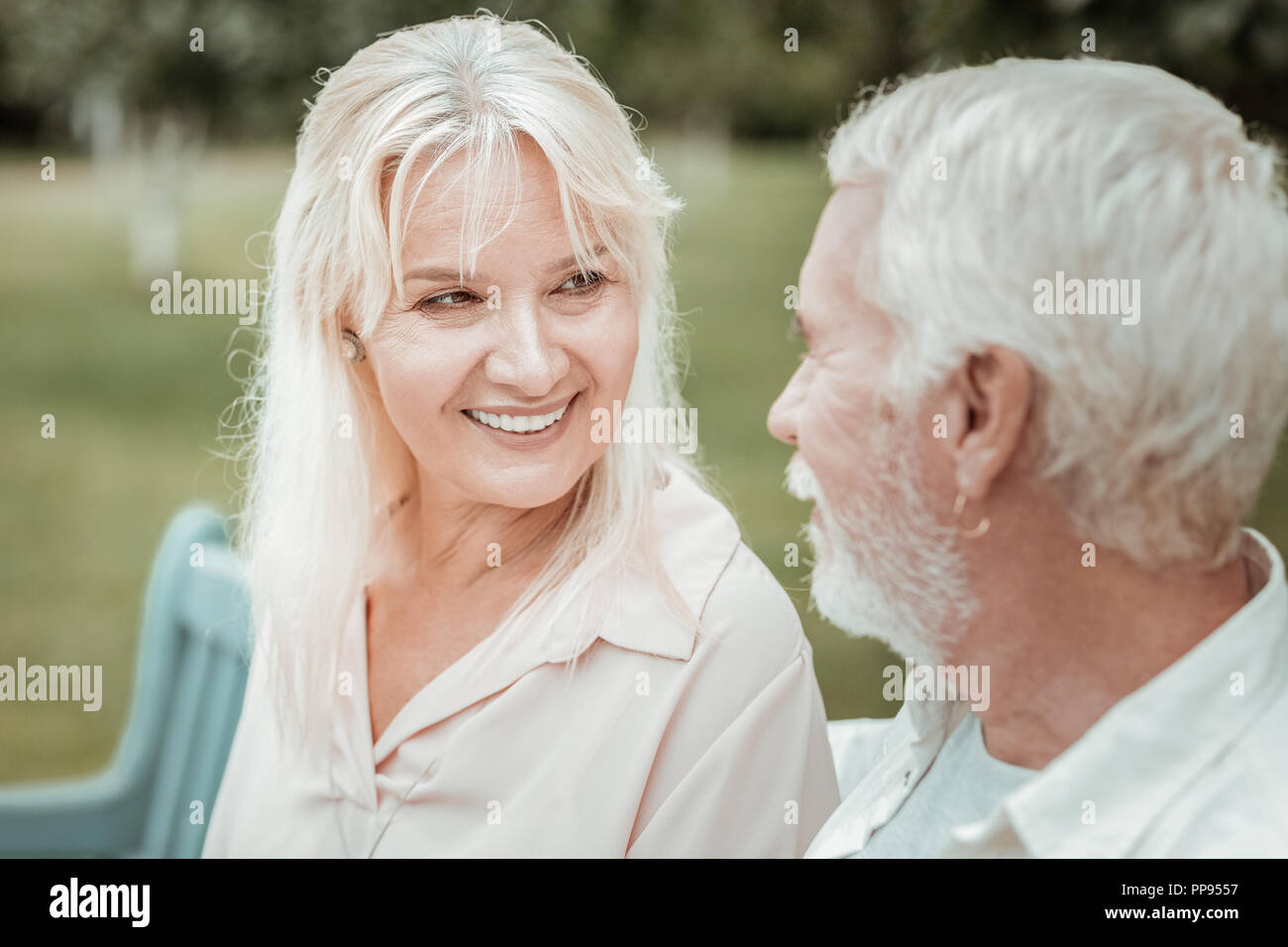 Kind female person looking with love at her partner Stock Photo - Alamy